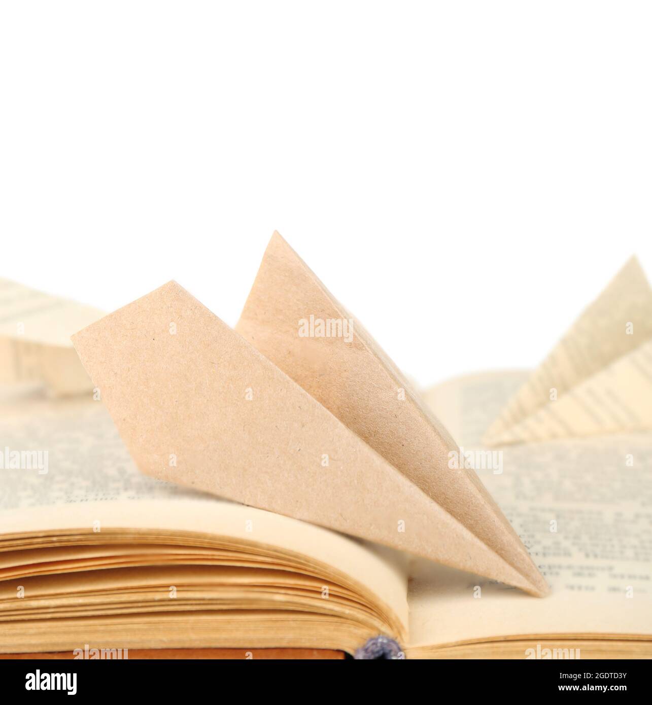Origami airplanes on old book, on white background Stock Photo - Alamy