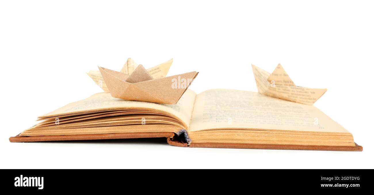 Origami boat on old book, isolated on white Stock Photo - Alamy
