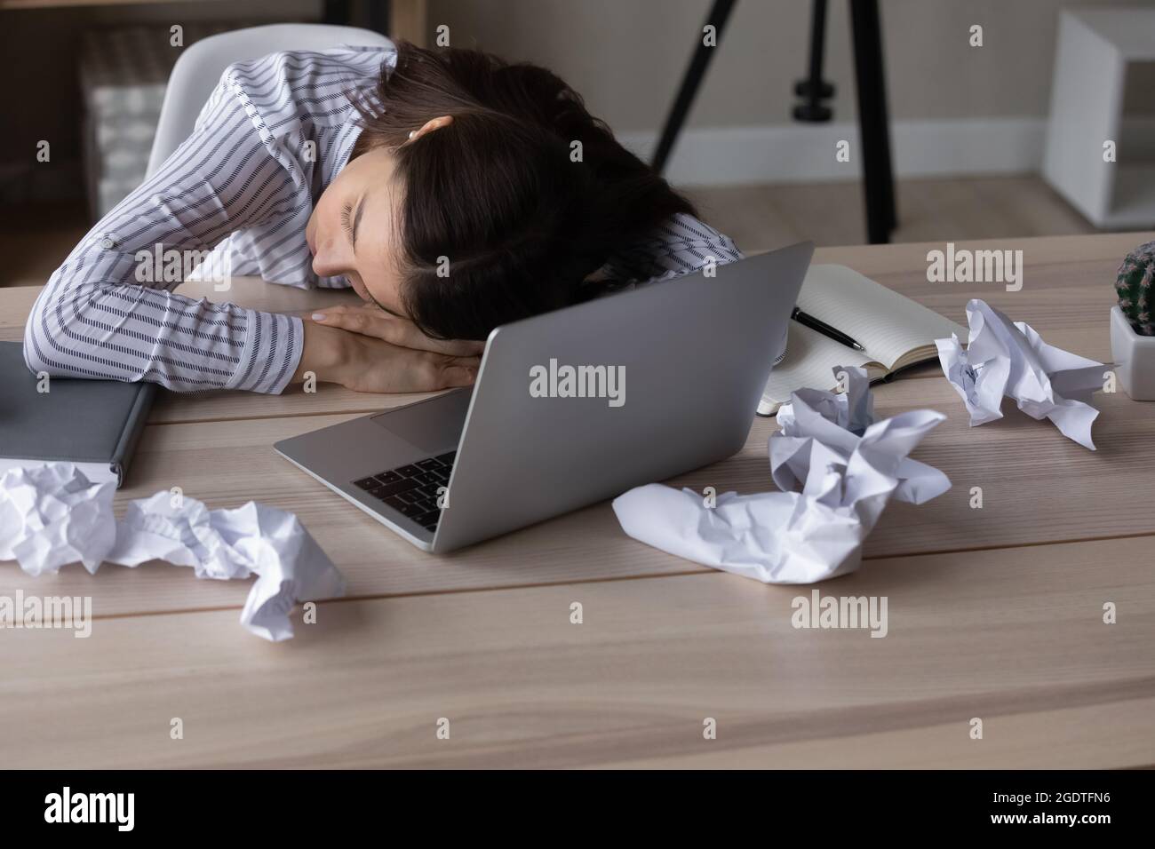 Exhausted woman fall asleep on desk at workplace Stock Photo - Alamy