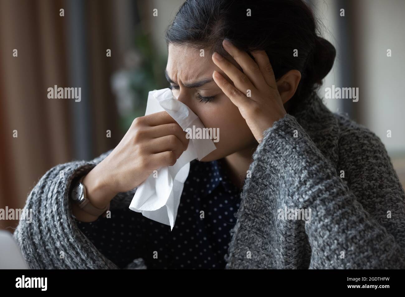 Unhealthy Indian woman feel sick at workplace Stock Photo - Alamy