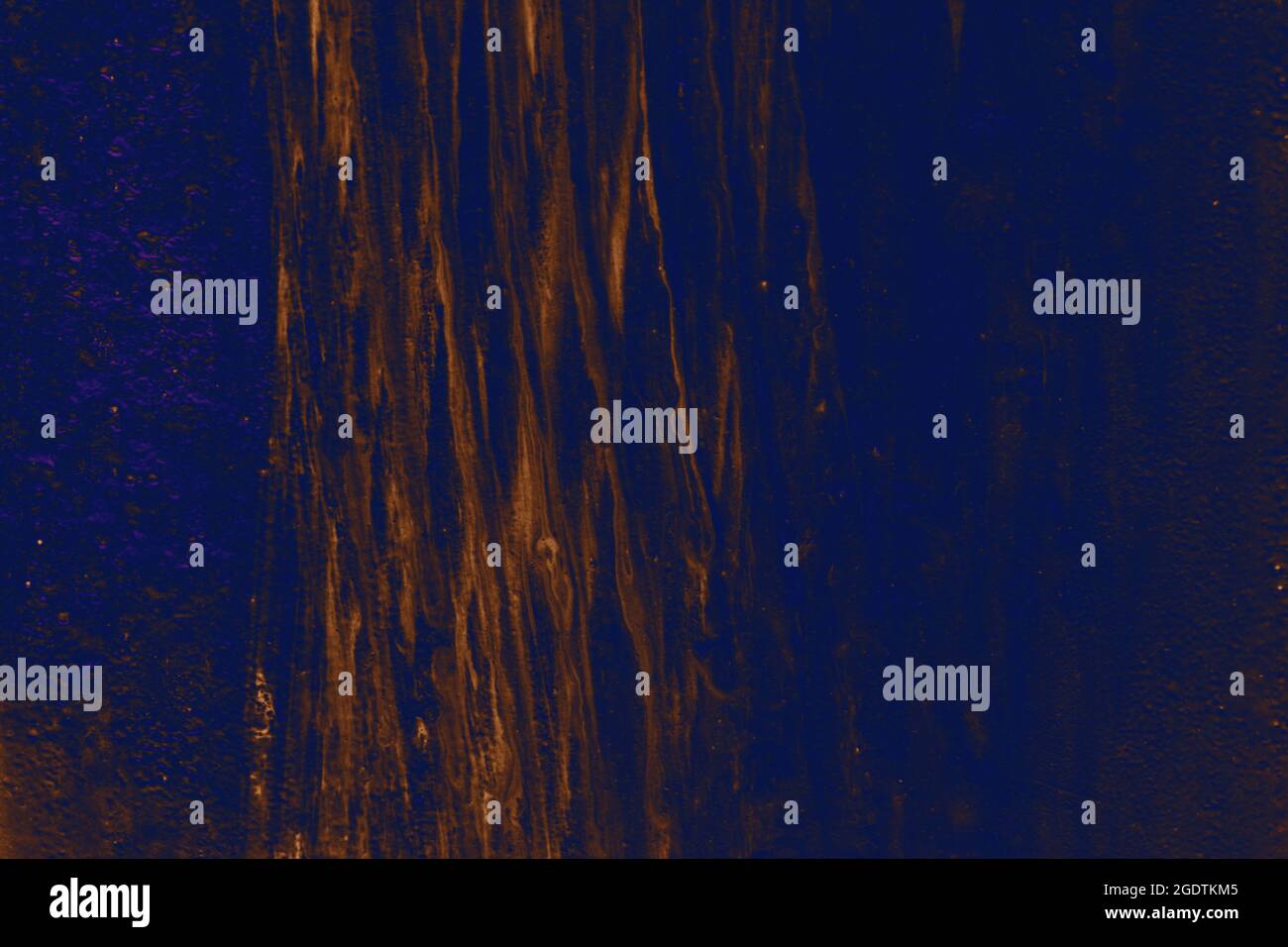 An aged blue wall background with orange streaks and grunge texture ...