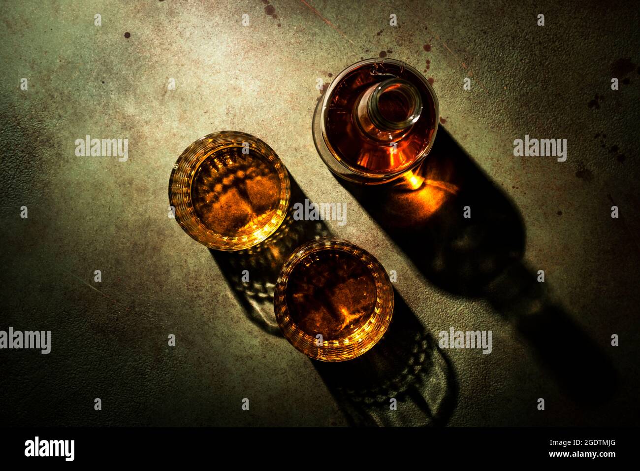 American bourbon whiskey in glasses and bottle, rusty green background ...