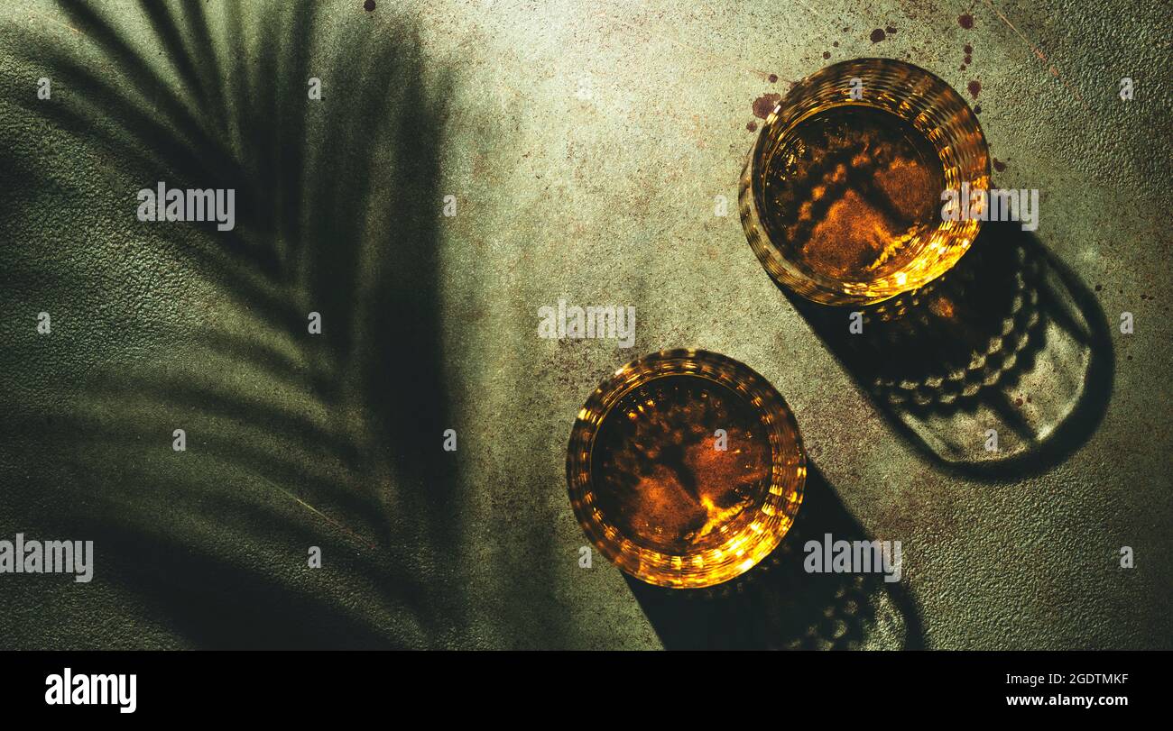 American bourbon whiskey in glasses, rusty green background with shadow ...