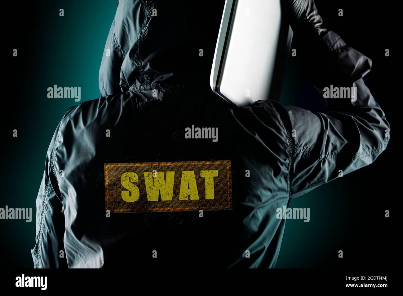 Hacker with a laptop on his shoulder on a dark background. Cybercrime ...