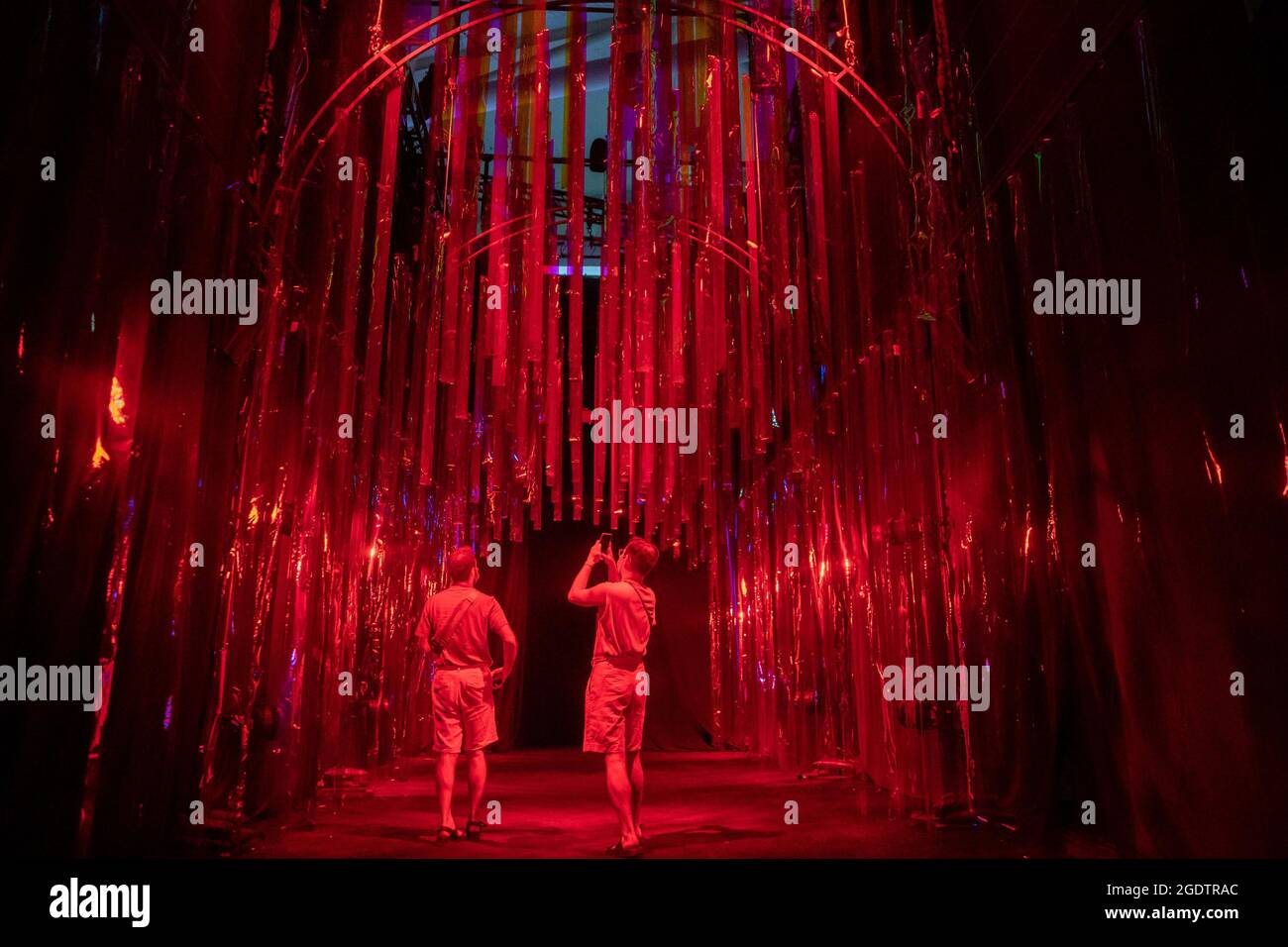 People surrounded by crystal light display at Beyond Monet exhibit.From ...