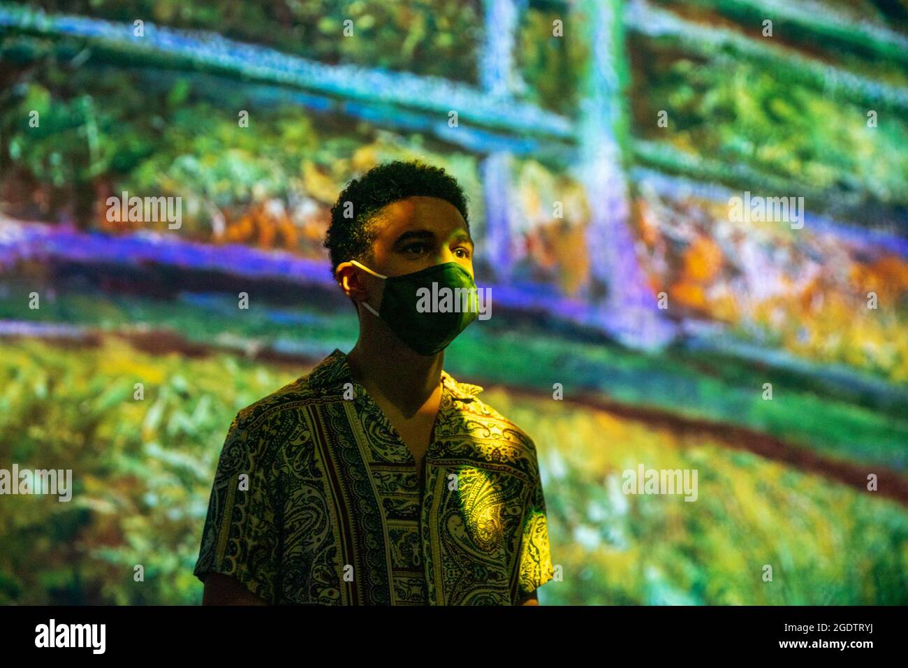Toronto, Canada. 11th Aug, 2021. A man attends the Beyond Monet exhibit ...