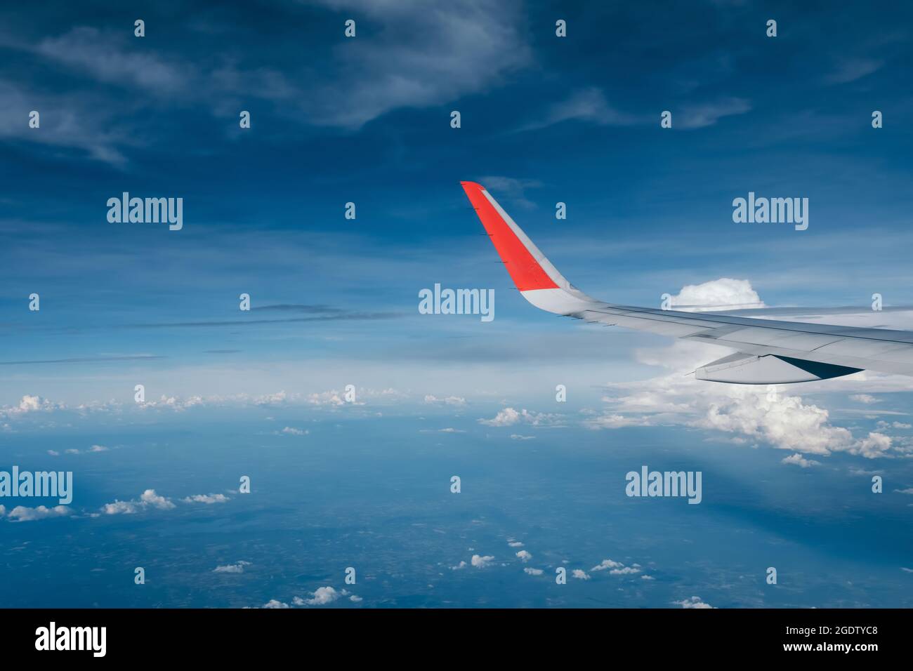 red winglet in graduated dark blue sky Stock Photo - Alamy