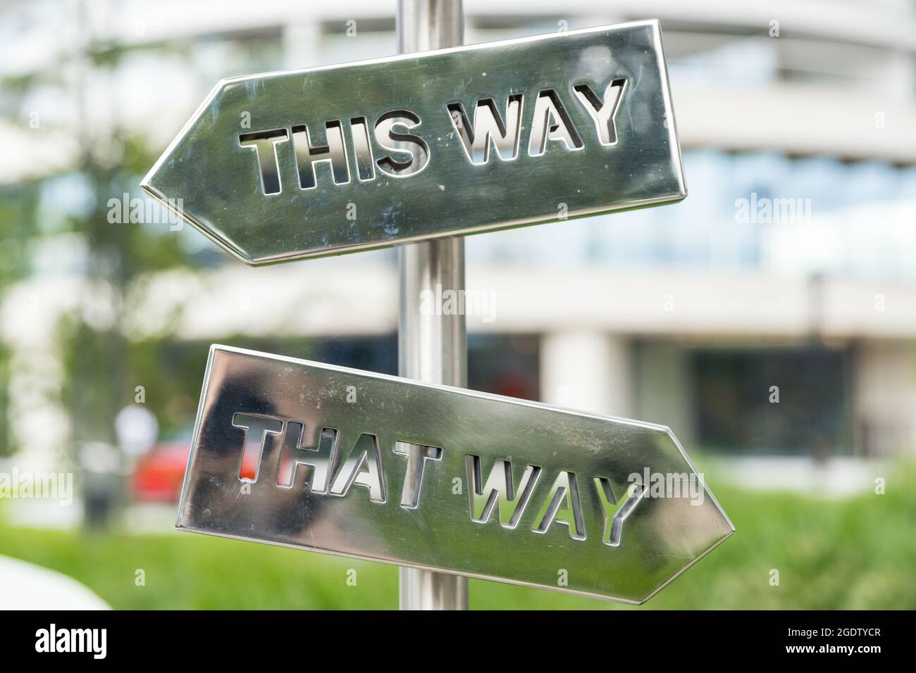 silvery arrow signs pointing in opposite directions Stock Photo - Alamy