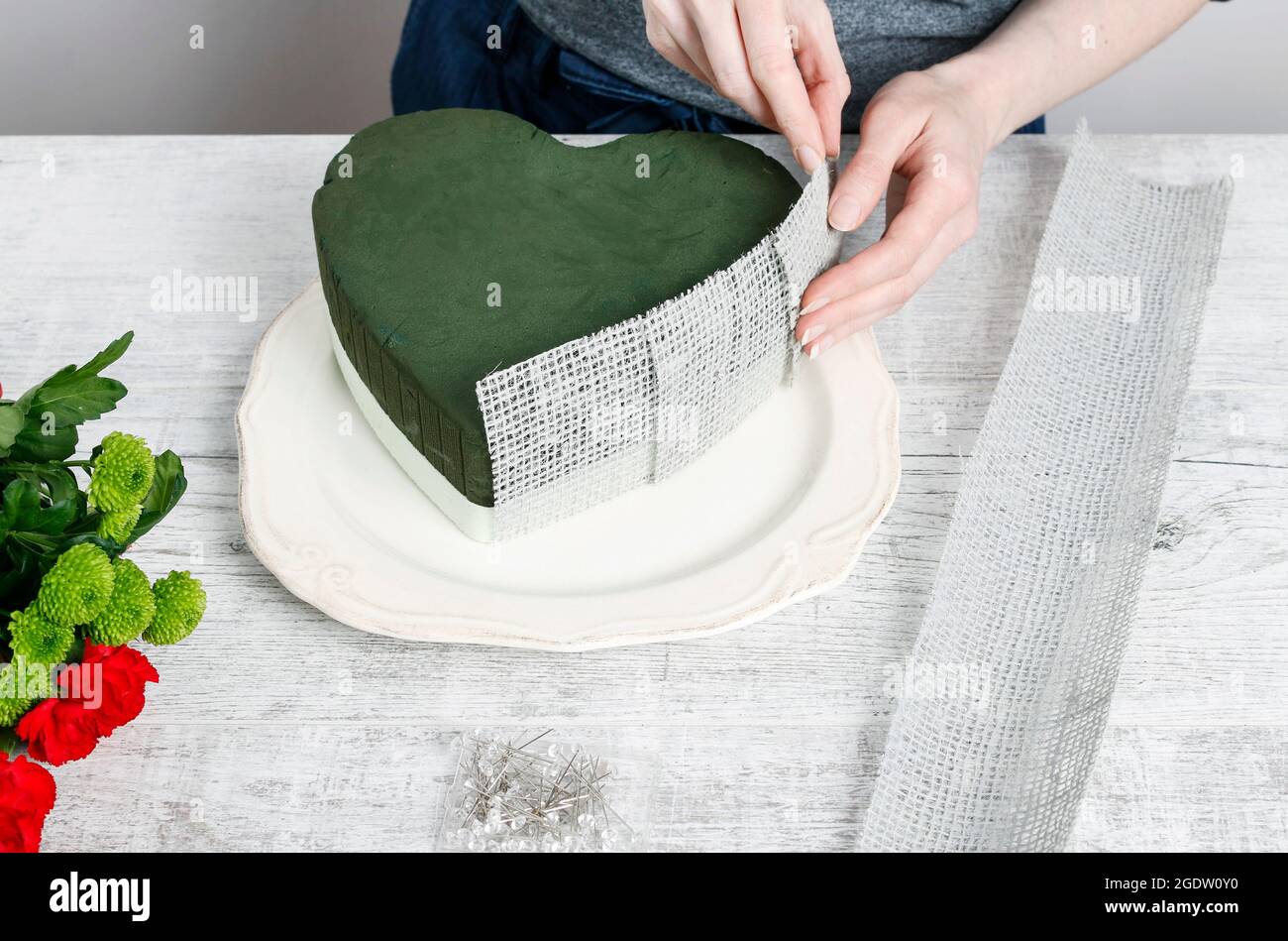 Florist at work: How to make floral arrangement in heart shape with carnations, chrysanthemums ...