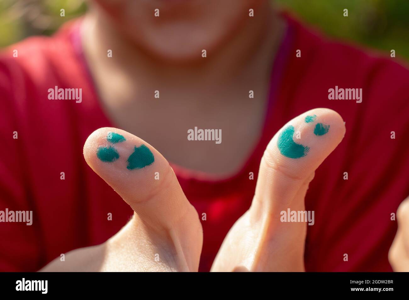 painted smiles on thumbs, education concept. Close up Stock Photo - Alamy