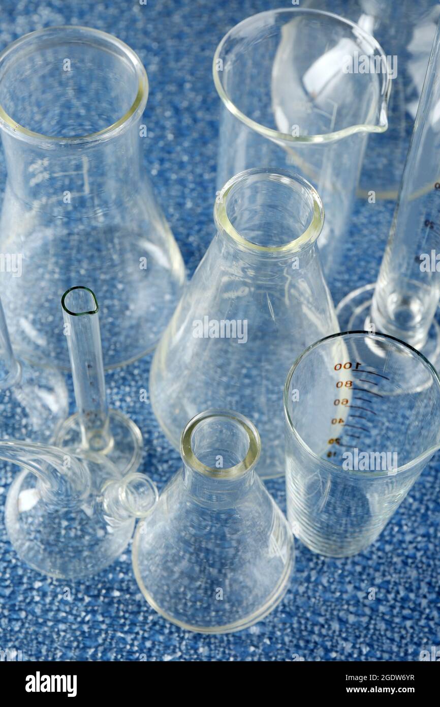 Different laboratory glassware on color background Stock Photo - Alamy