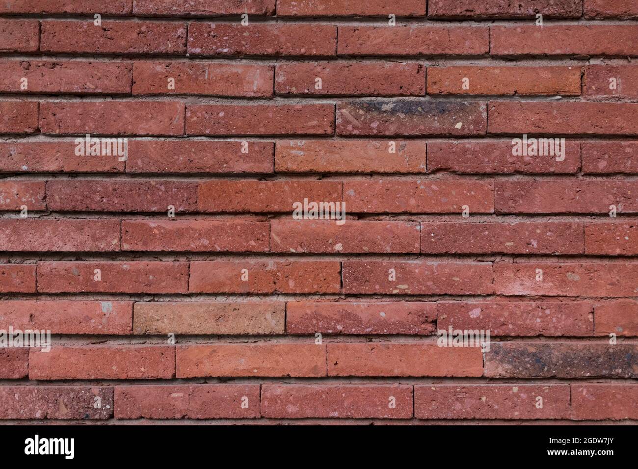 Texture of a wall made of old raw bricks. The walls are deep red Stock ...