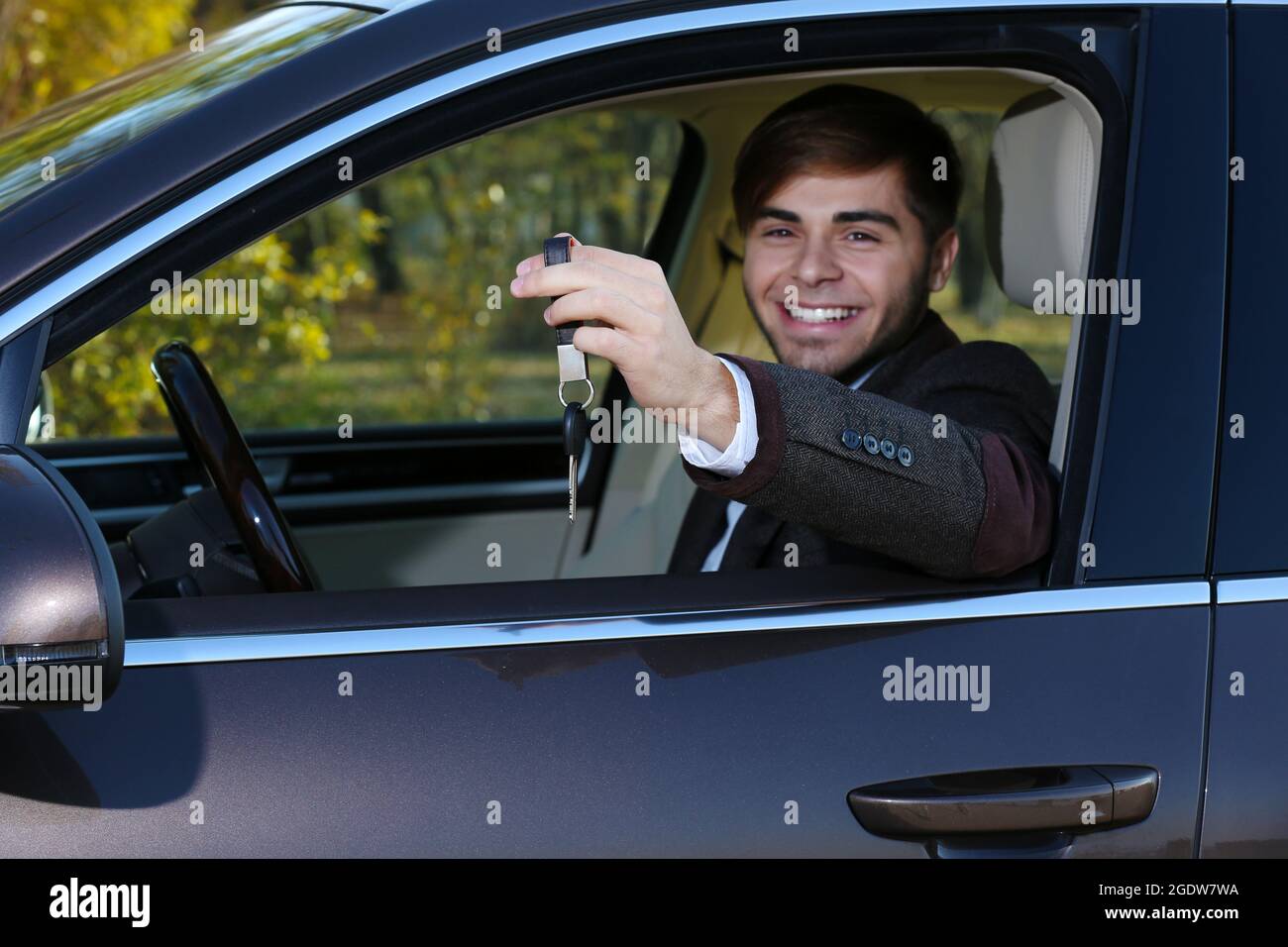 Man with car key in car Stock Photo - Alamy