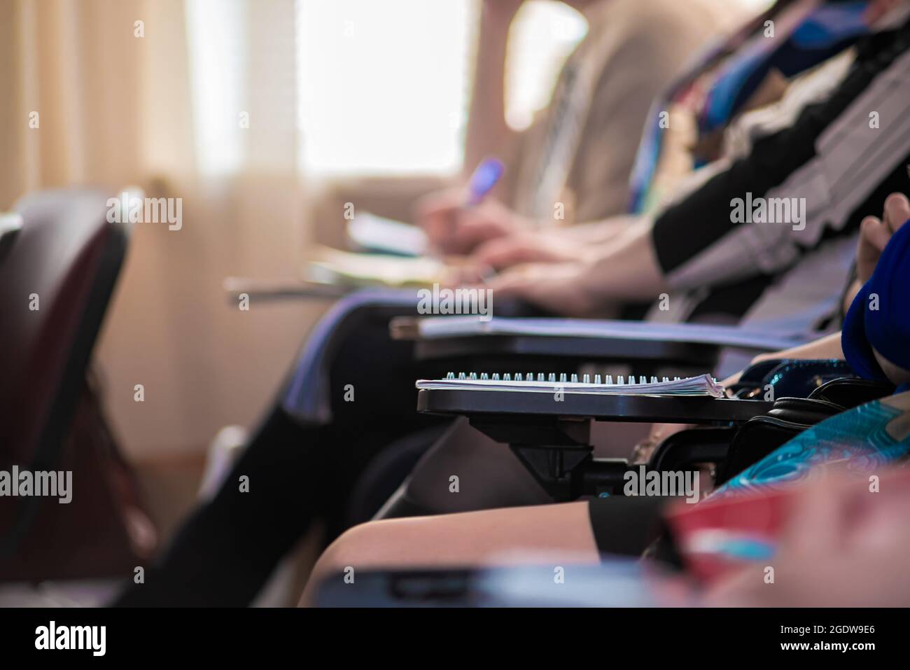 Sit in a row hi-res stock photography and images - Alamy