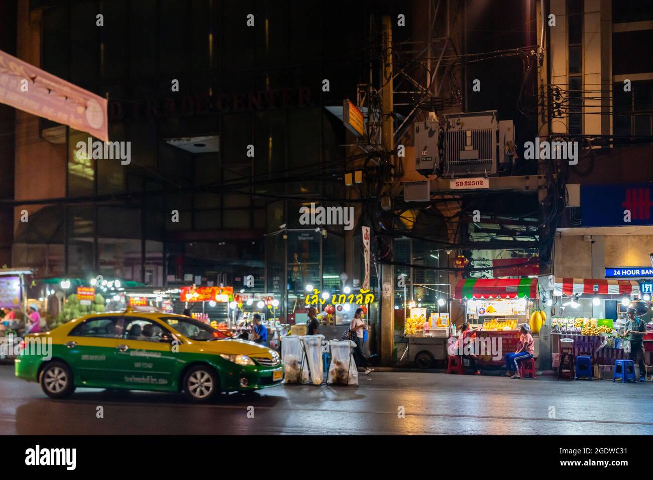 Taxi cab riding past food stalls, night, on Yaowarat Rd, Chinatown, Bangkok, Thailand Stock ...
