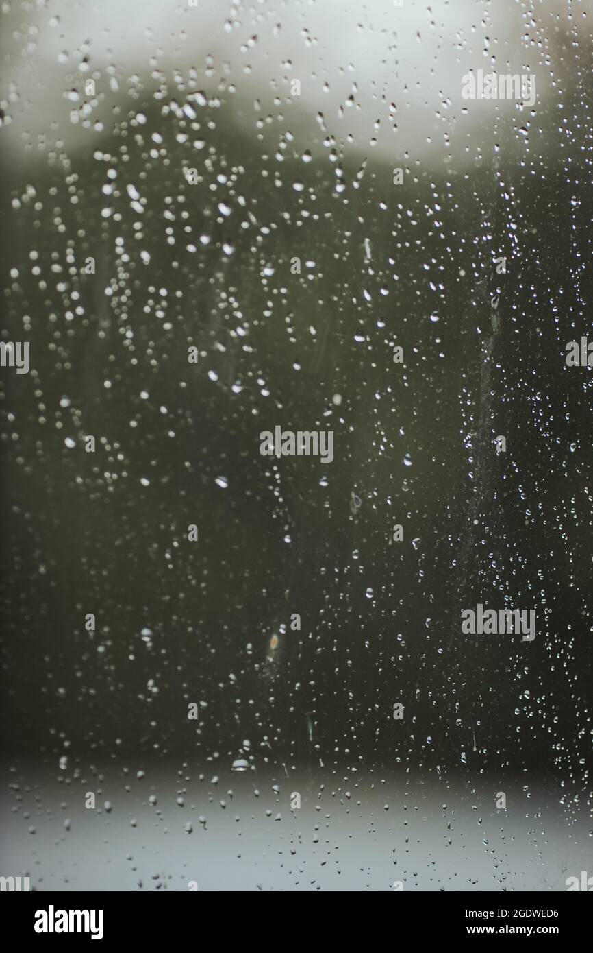 A vertical shot of raindrops on a window Stock Photo - Alamy
