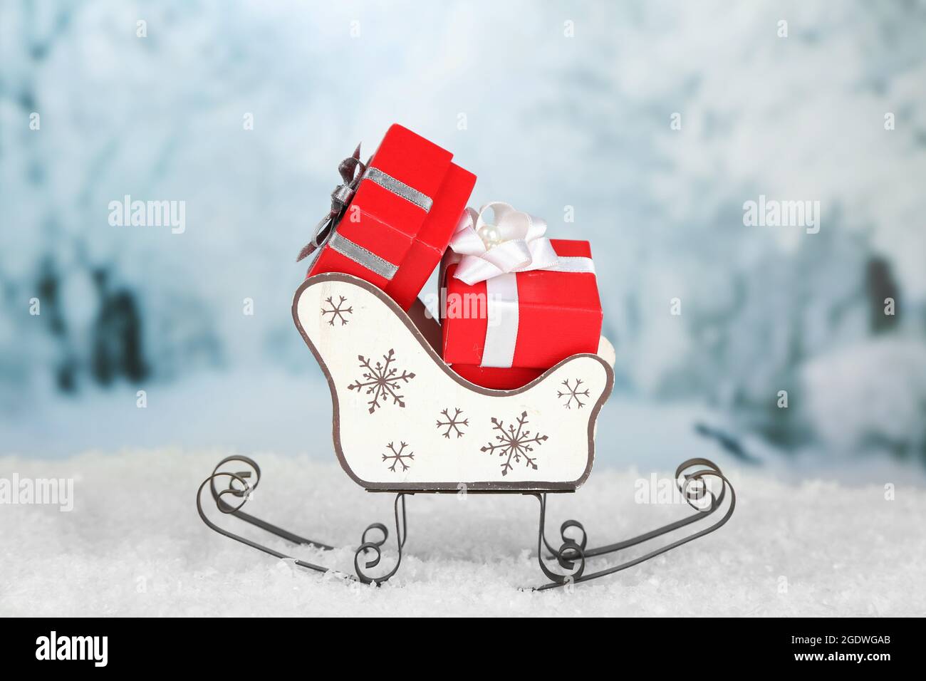 Wooden toy sledge with Christmas gifts on nature background Stock Photo ...