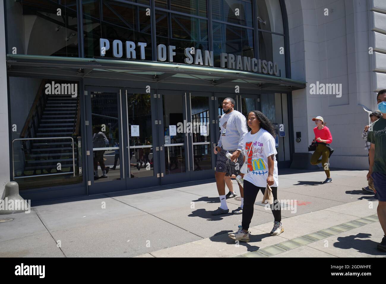 People without face masks walk along the port of san Francisco.The ...