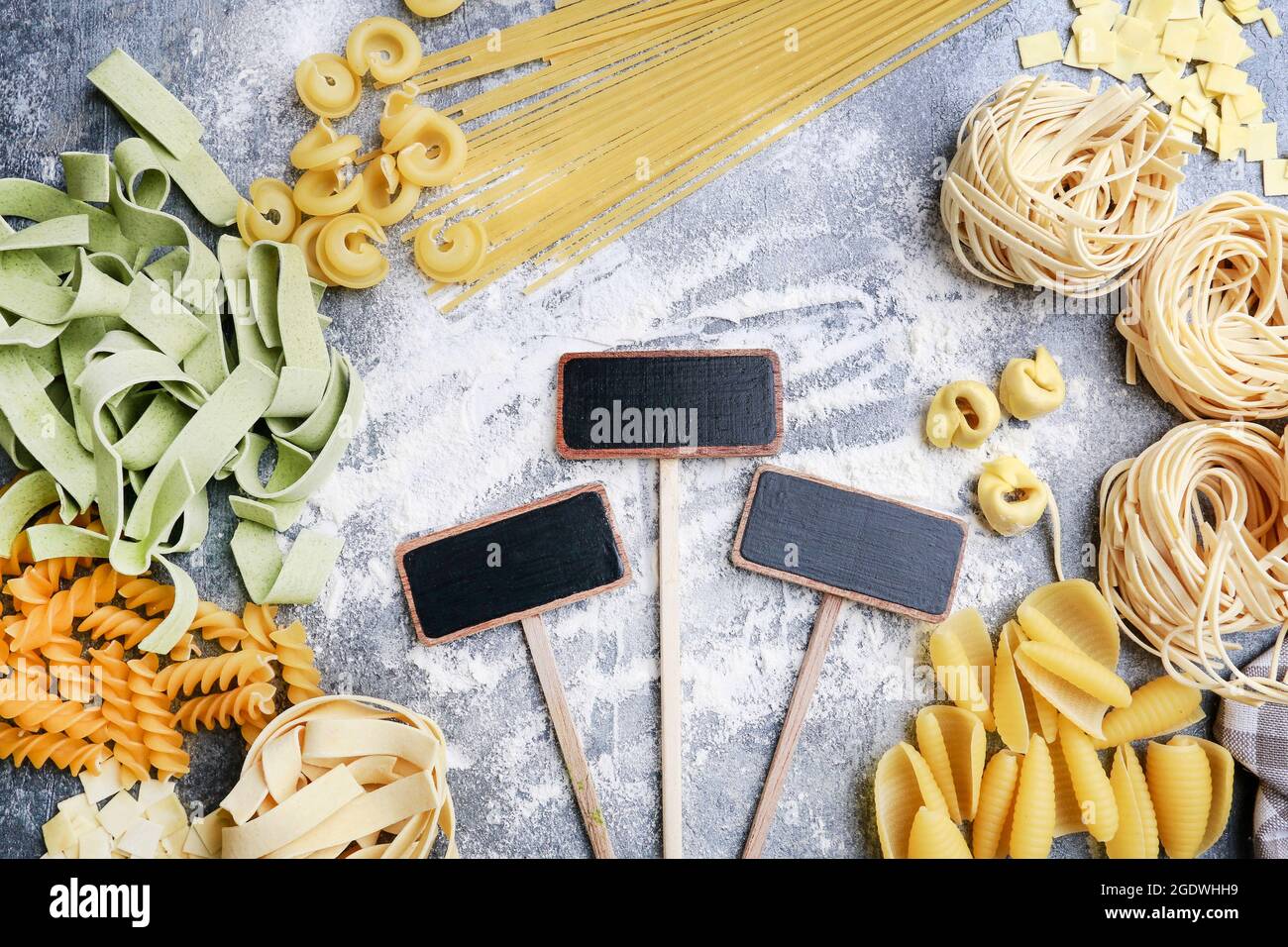 Blank blackboard label among mixed types and shapes of italian pasta on ...