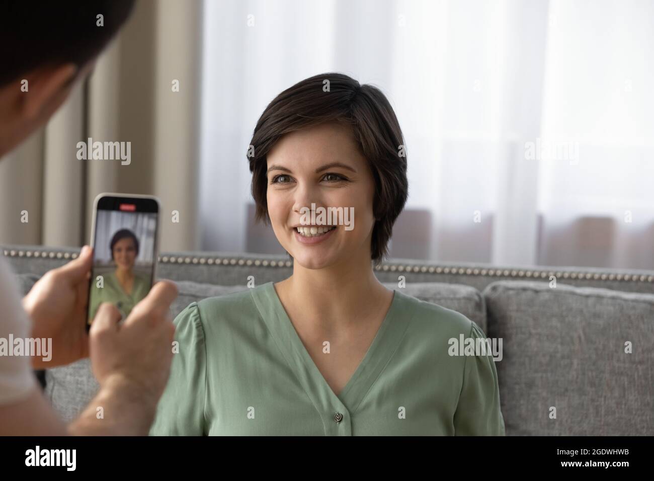 Man taking head shot picture of happy pretty young woman Stock Photo ...