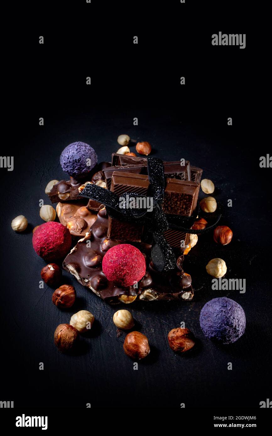 Chocolate bar, crushed pieces of dark chocolate and nuts. Praline ...