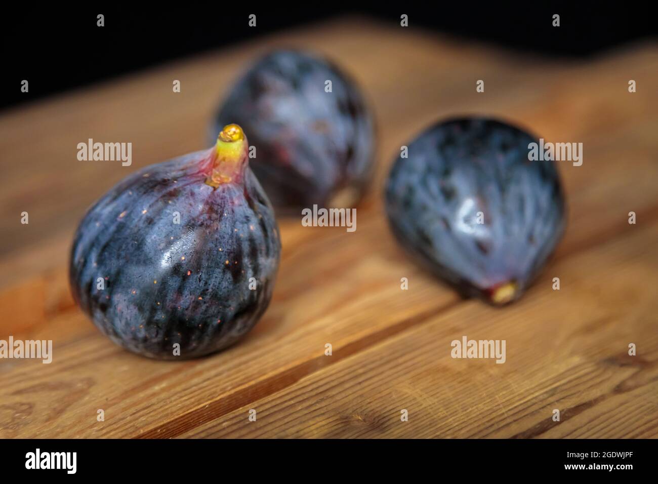 Fresh purple figs on a wooden background from old boards. Raw exotic ...