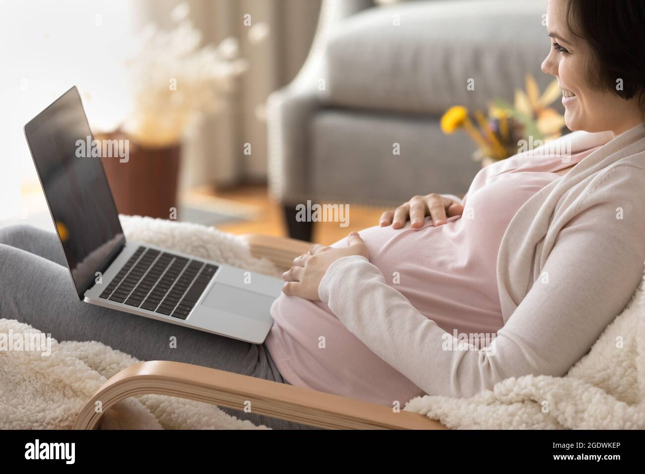 Happy late pregnant girl using laptop, using virtual telemedicine app ...