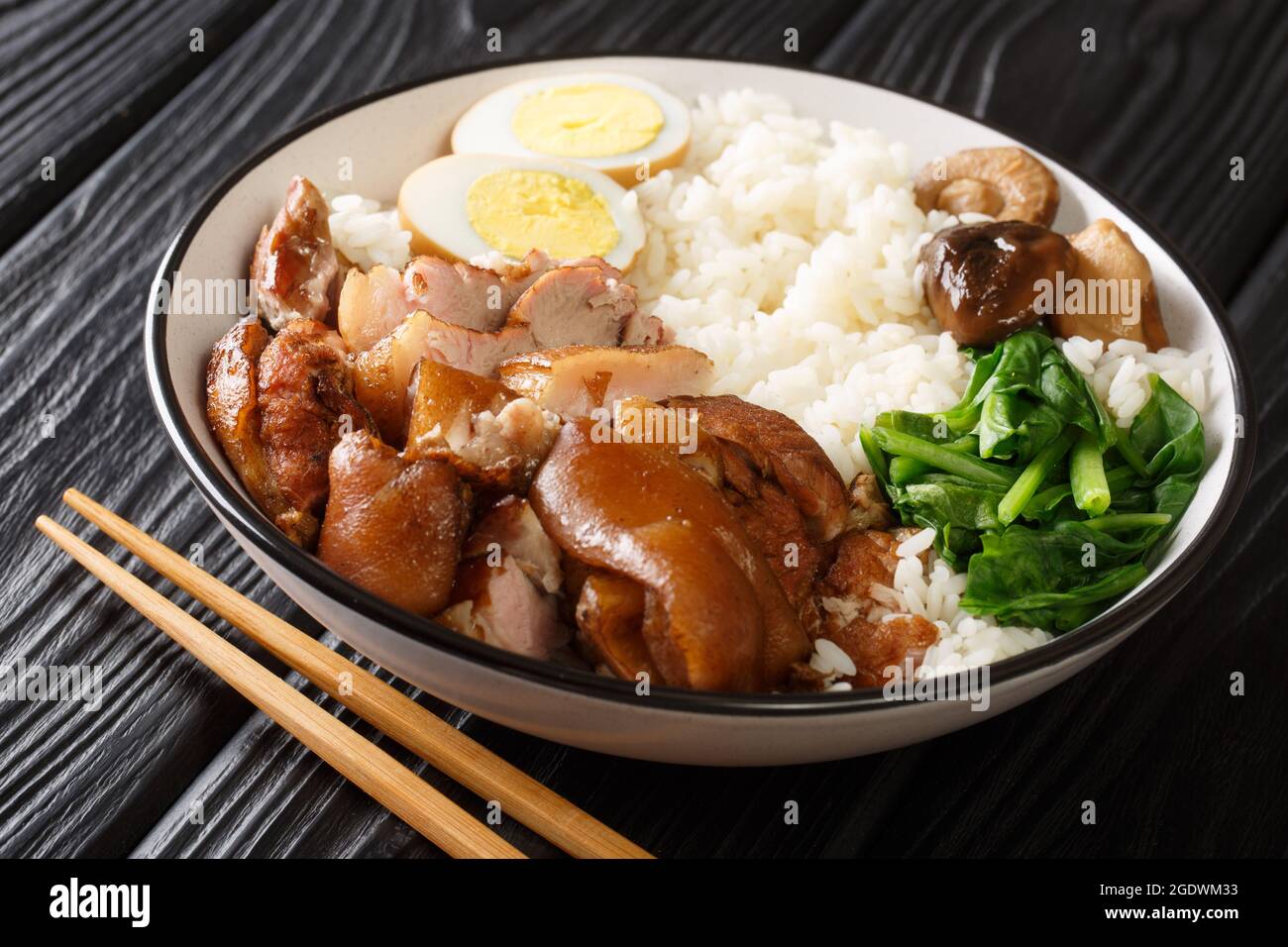 Thai Style Braised Pork Leg on Rice Khao Kha Moo closeup in the bowl on ...