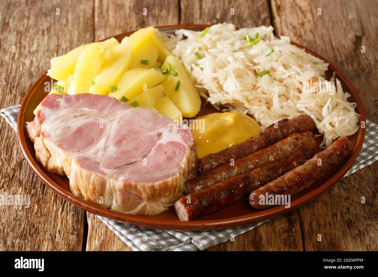 Traditional German food smoked sausage, Kassler pork neck, sauerkraut ...