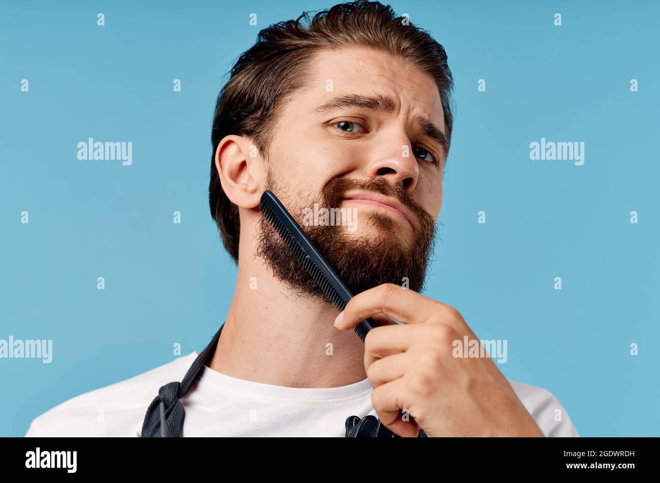 male hairdresser modern hairstyle blue background Stock Photo - Alamy