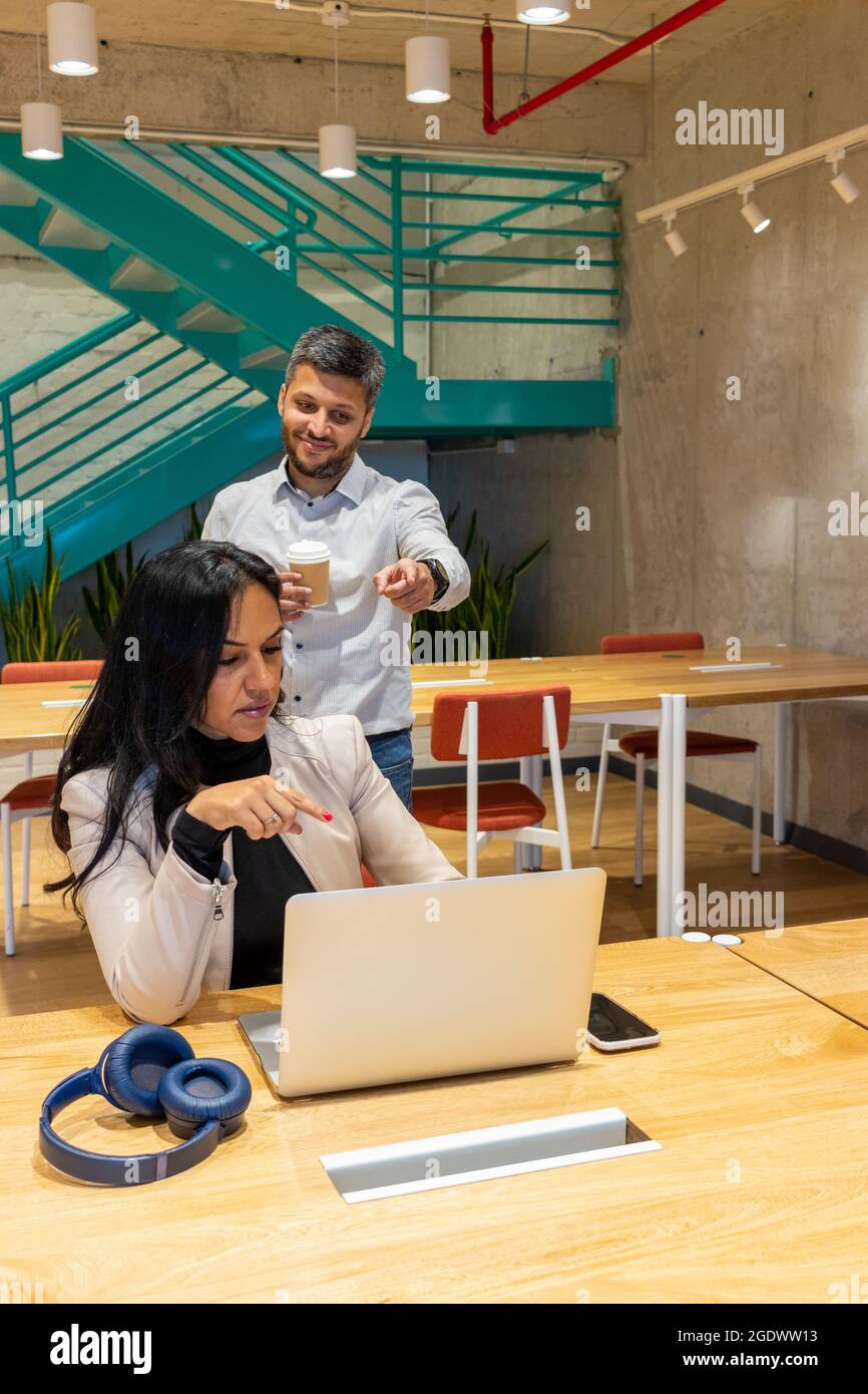 Coworkers having a work conversation while having black coffee Stock ...