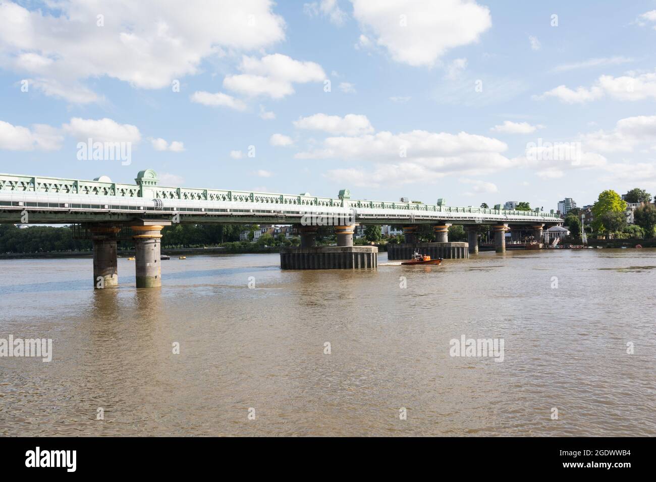 An RNLI inflatable lifeboat passes under Fulham Railway Bridge, Fulham ...
