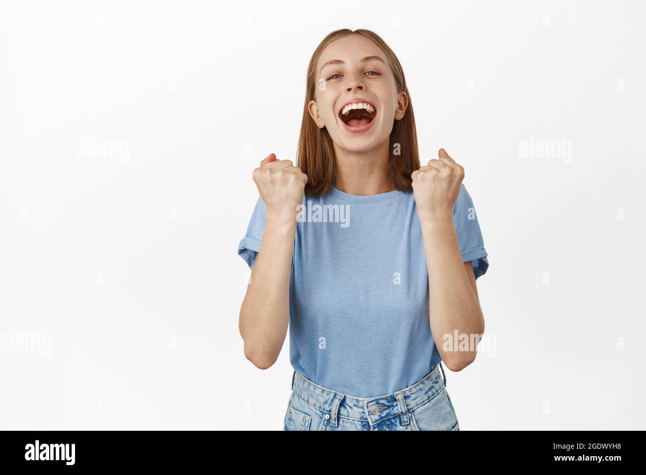 Finally. Relieved and happy young woman scream from success and triumph ...