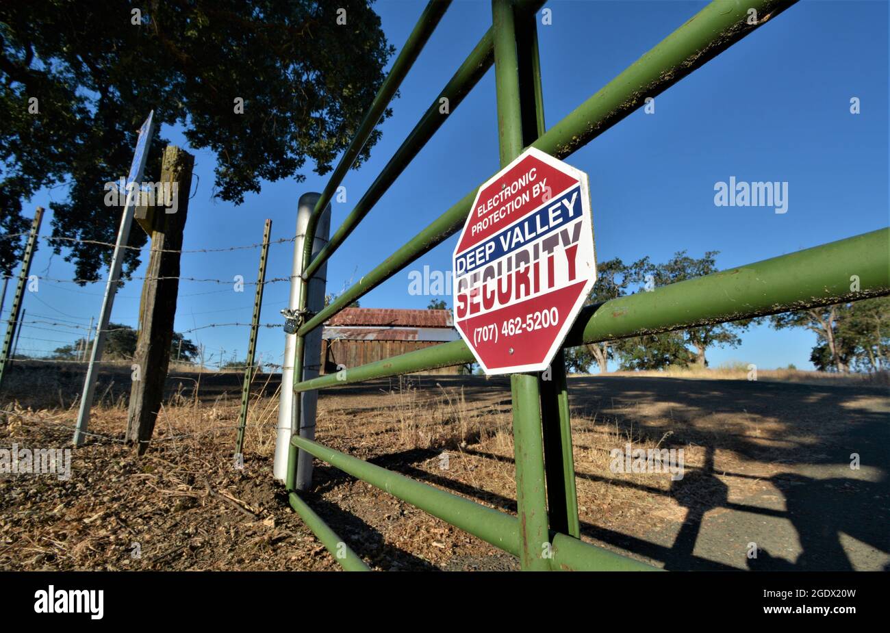 Old wooden farmers barn behind paddle locks and chains and keep out ...