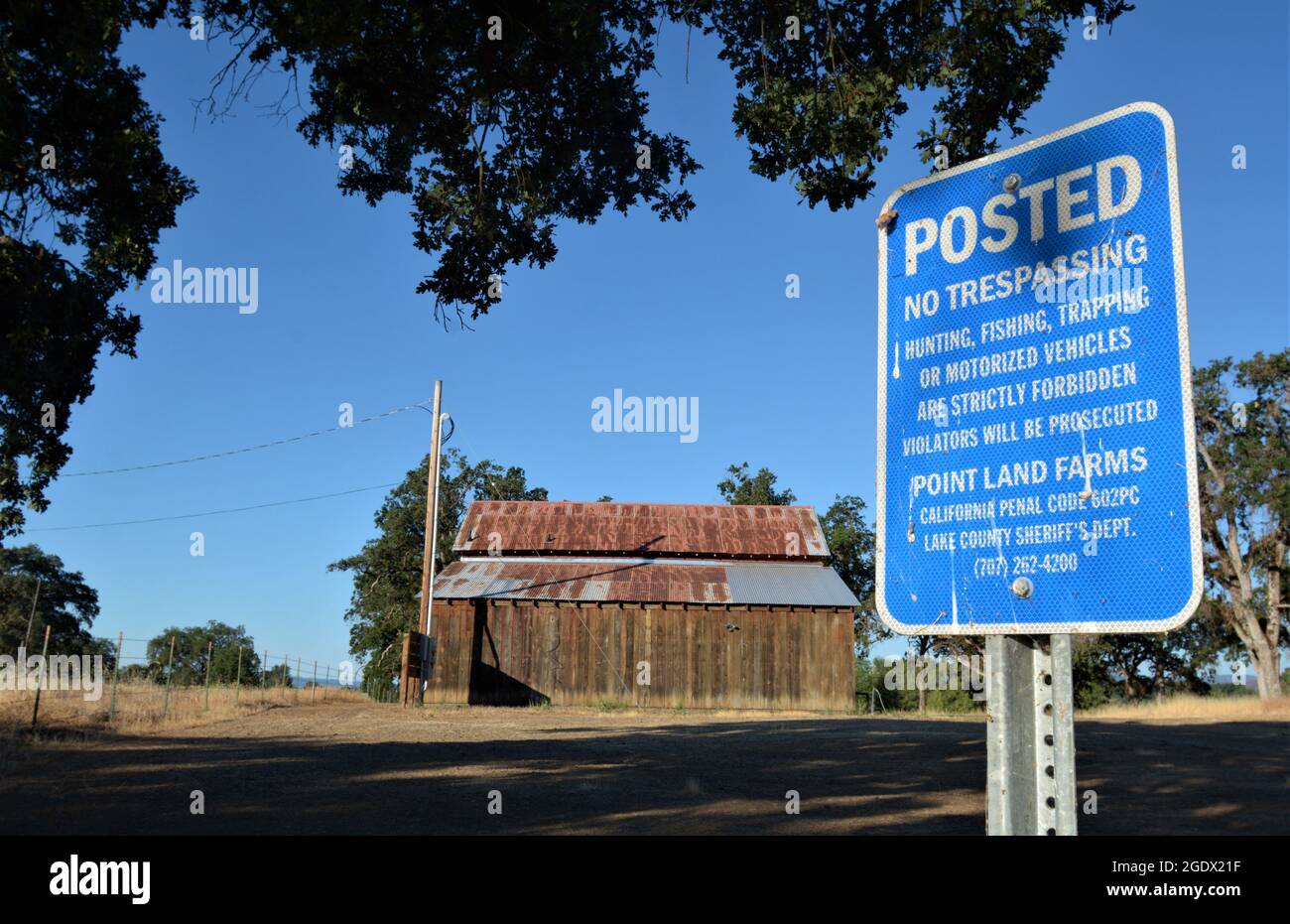 Old wooden farmers barn behind paddle locks and chains and keep out ...