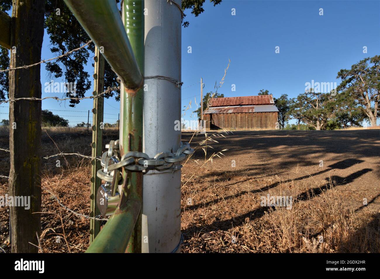 Old wooden farmers barn behind paddle locks and chains and keep out ...