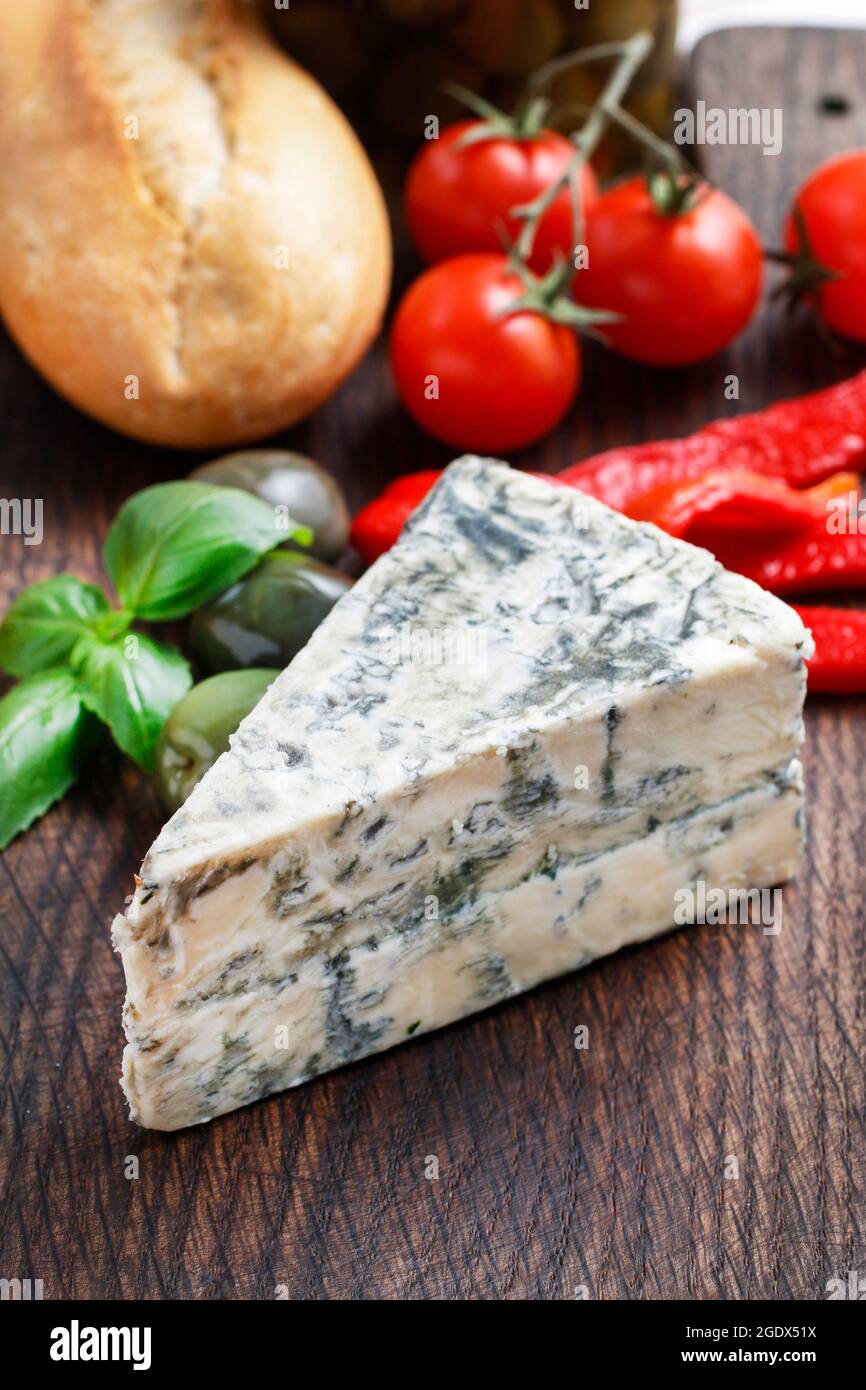 Mediterranean cuisine: blue cheese, tomatoes, olives, basil plant ...