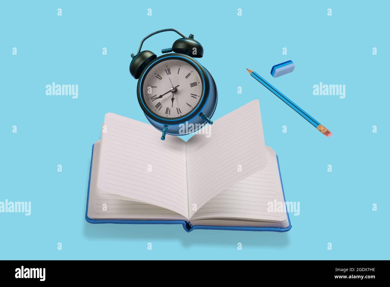 Modern creative idea made of a notebook, pencil, eraser and alarm clock ...