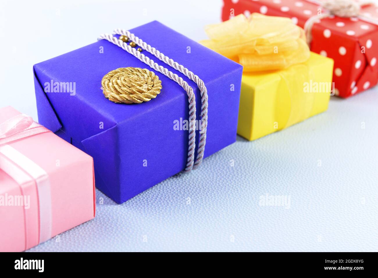 Colorful boxes on blue uneven background Stock Photo - Alamy