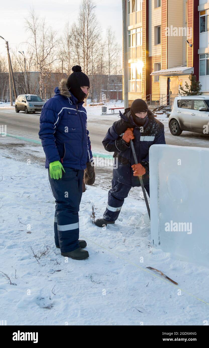 Portrait of a worker busy assembling an ice block on an ice town Stock ...