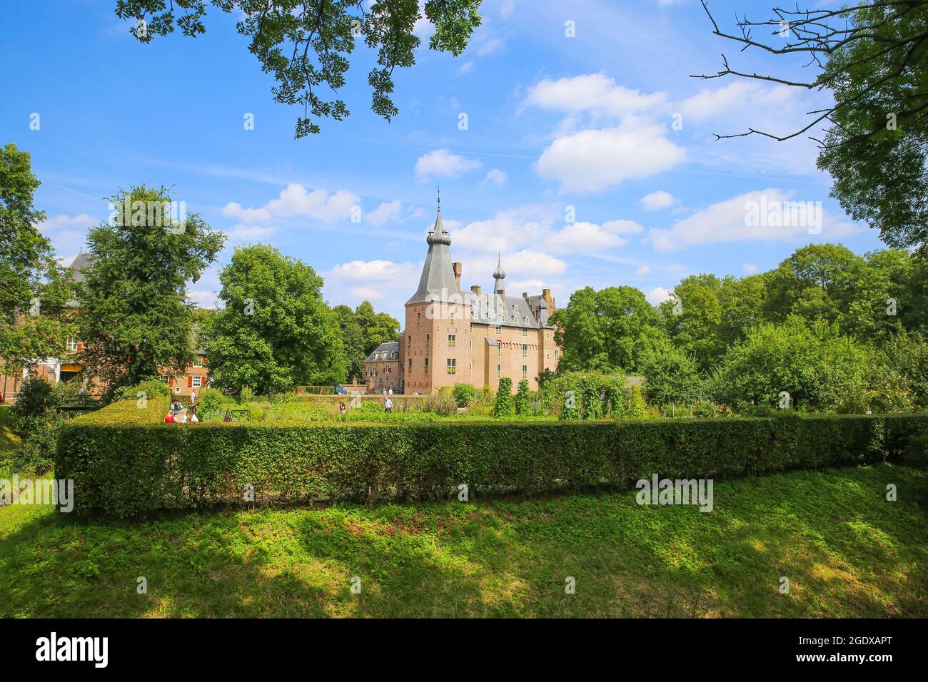 View over garden hedge on medieval dutch castle from 14th century with ...