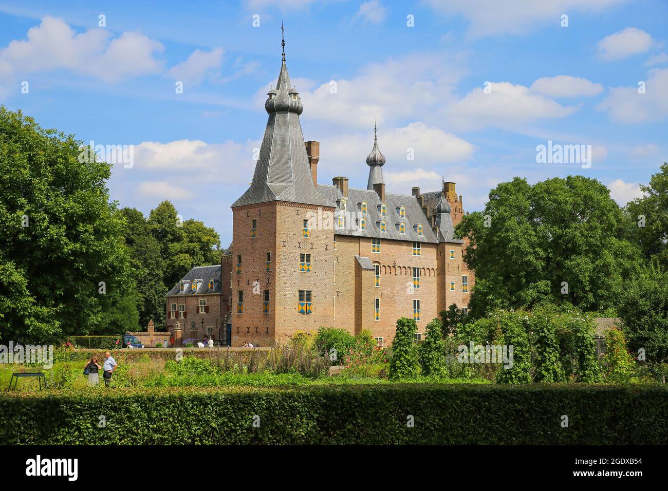 View over garden hedge on medieval dutch castle from 14th century with ...