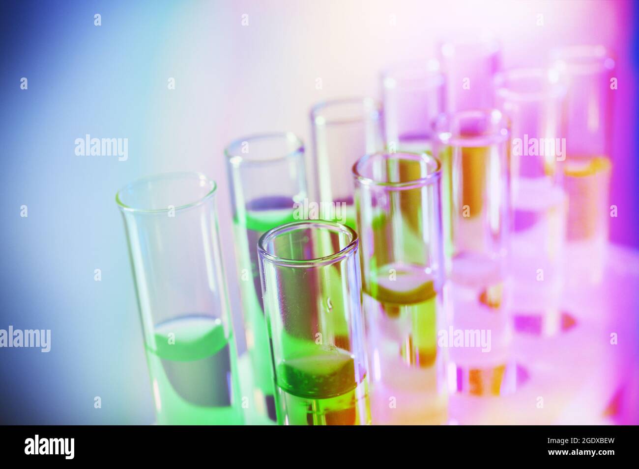 Color fluid in test-tubes on light background Stock Photo - Alamy
