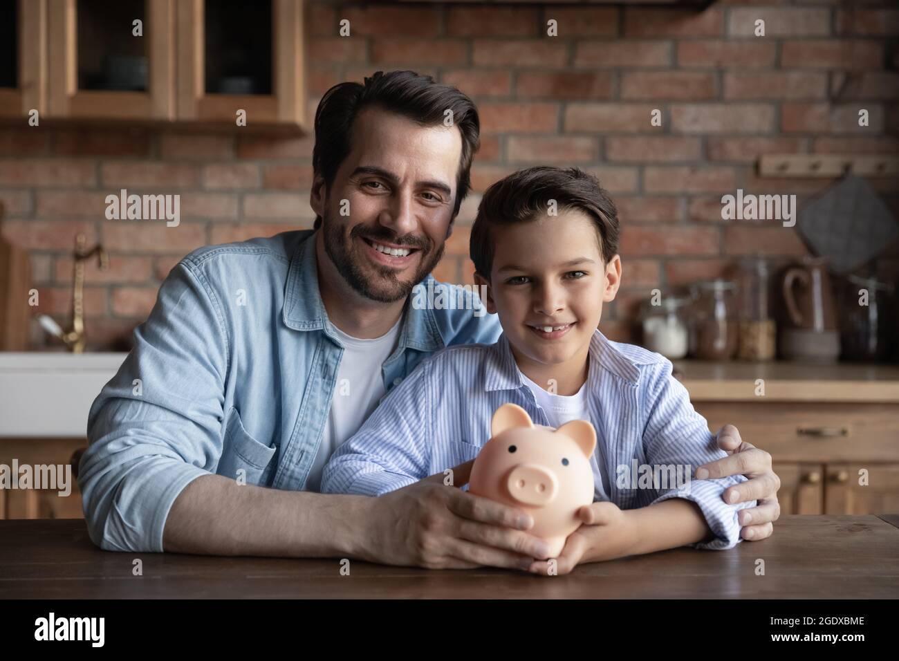 Portrait of young dad and son recommend saving Stock Photo - Alamy