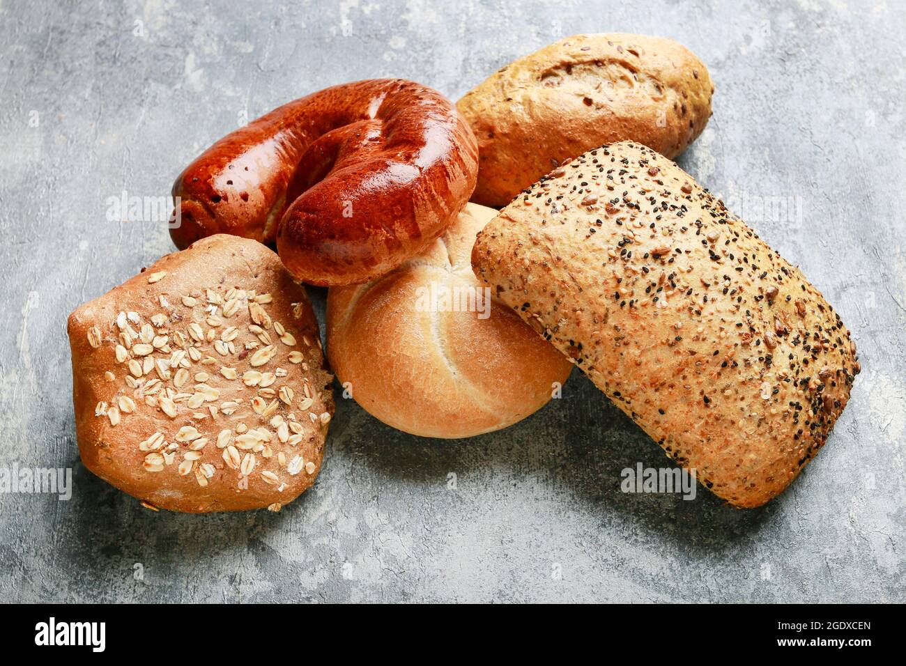 Assorted buns on grey stone background. Breakfast time Stock Photo - Alamy