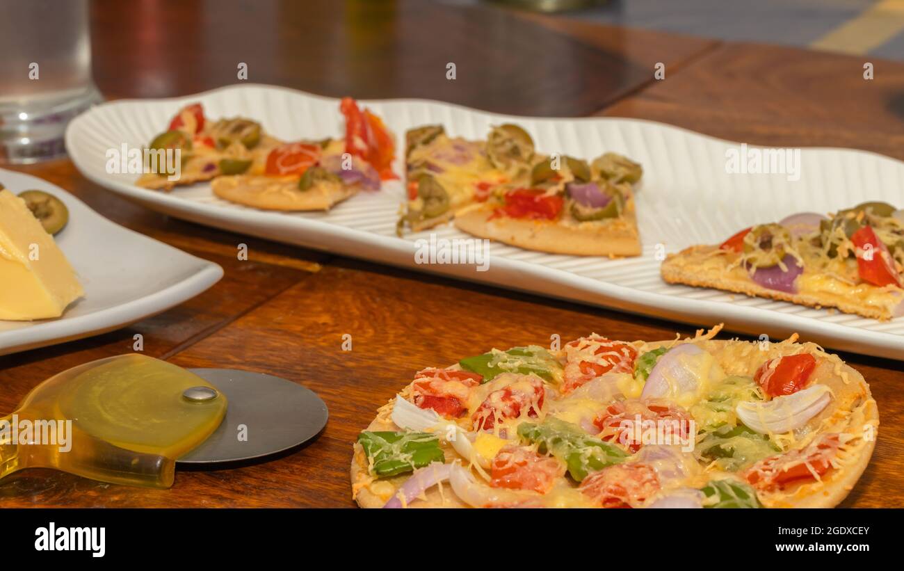 Freshly Baked and sliced pizza along with its ingredients served on ...