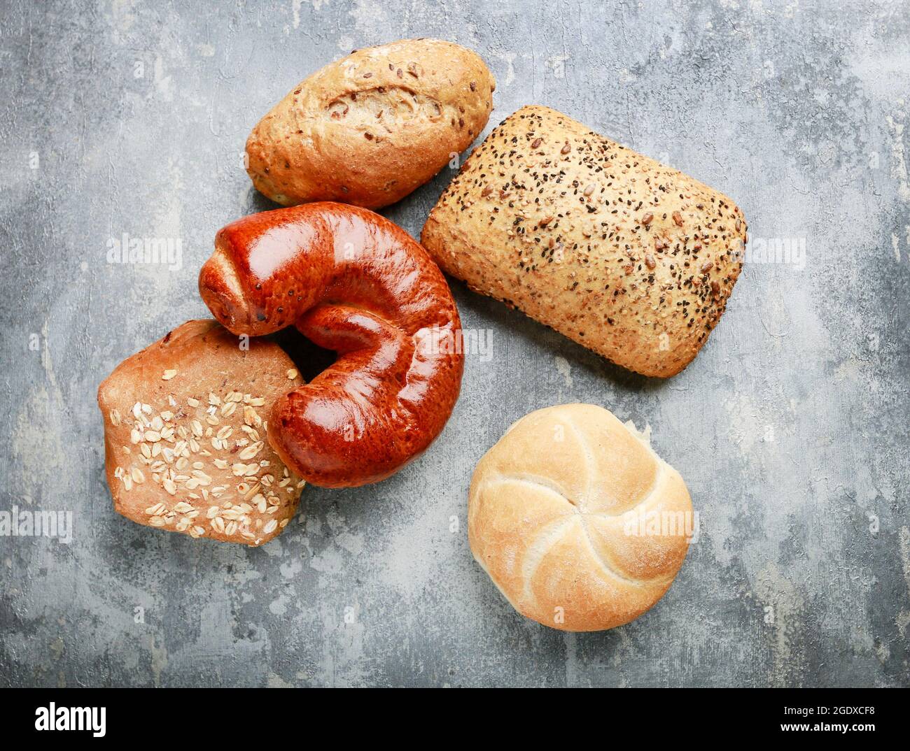 Assorted buns on grey stone background. Breakfast time Stock Photo - Alamy