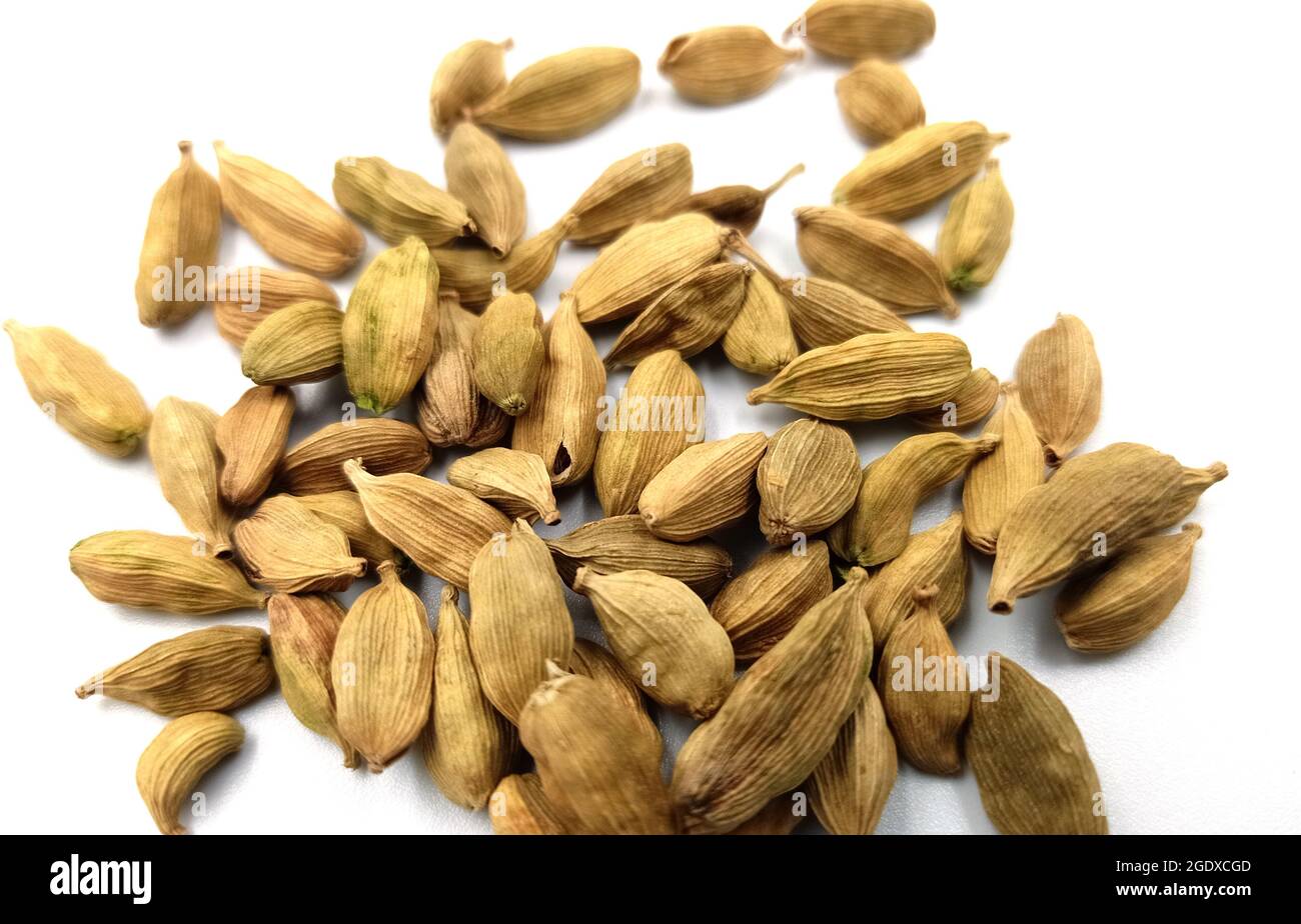A pile of cardamom seeds isolated on white background Stock Photo - Alamy