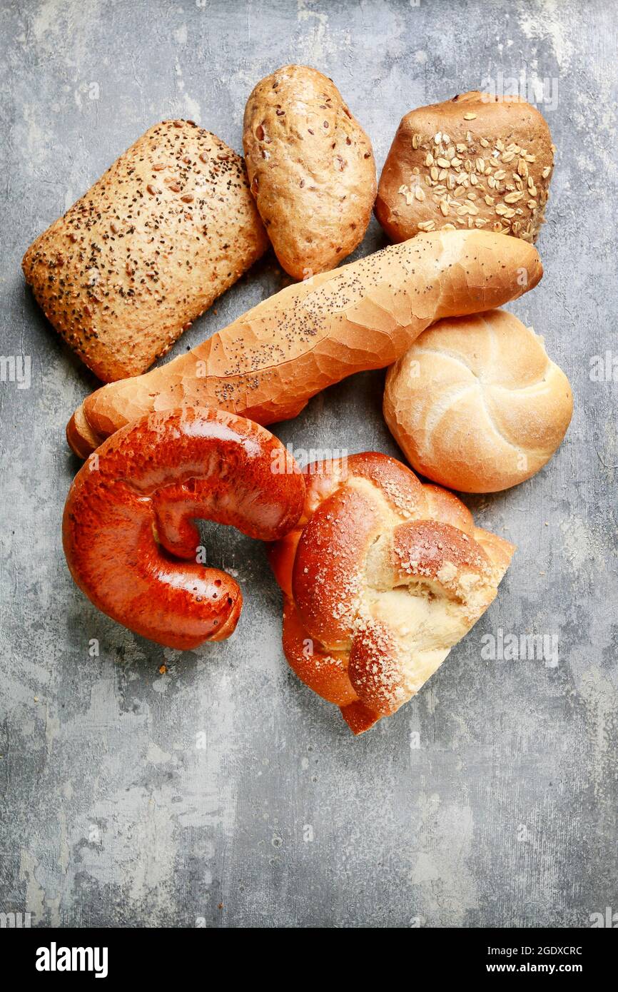Assorted buns on grey stone background. Breakfast time Stock Photo - Alamy
