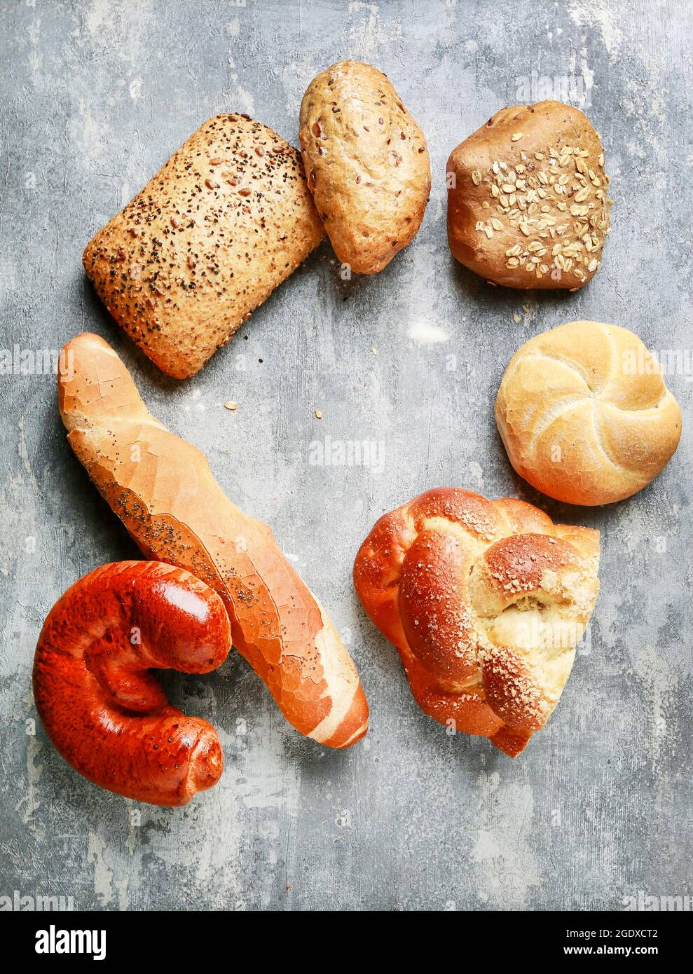 Assorted buns on grey stone background. Breakfast time Stock Photo - Alamy